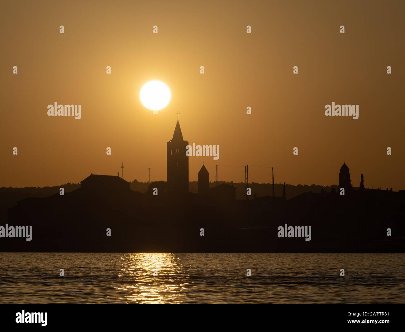 Sunset, silhouette of the church towers of Rab, town of Rab, island of ...