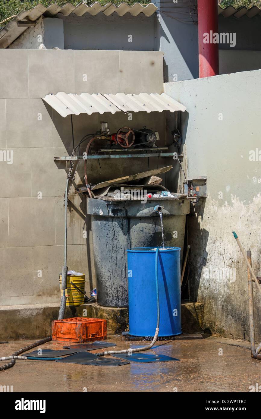 A rustic hydraulic system for a car wash service, in the messy corner ...
