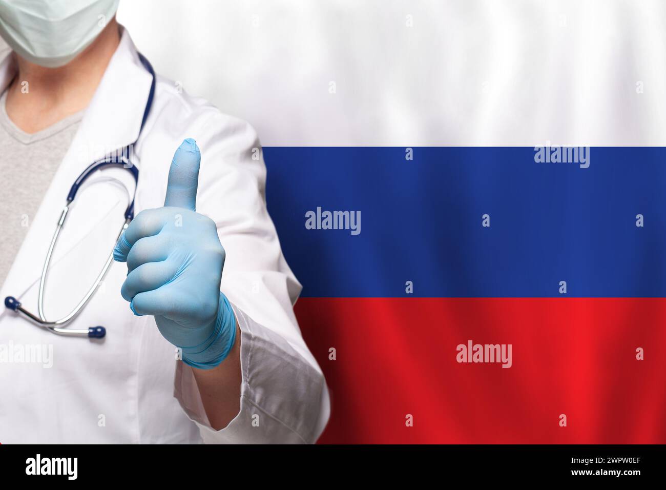 Russian doctor's hand showing thumb up positive gesture on flag of ...