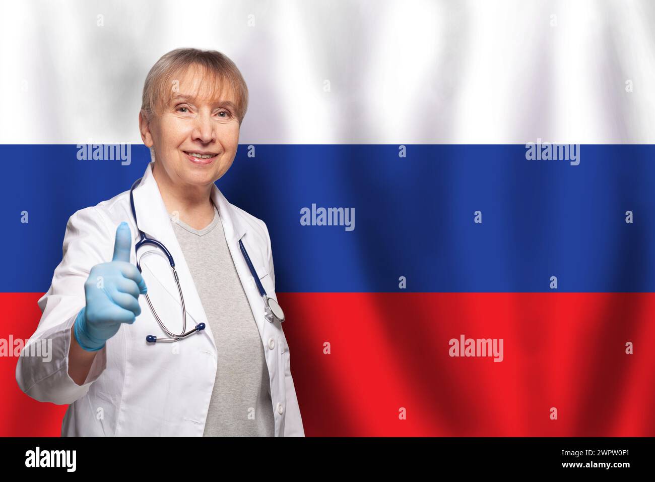 Russian smiling mature doctor woman holding stethoscope on flag of Russia background Stock Photo ...
