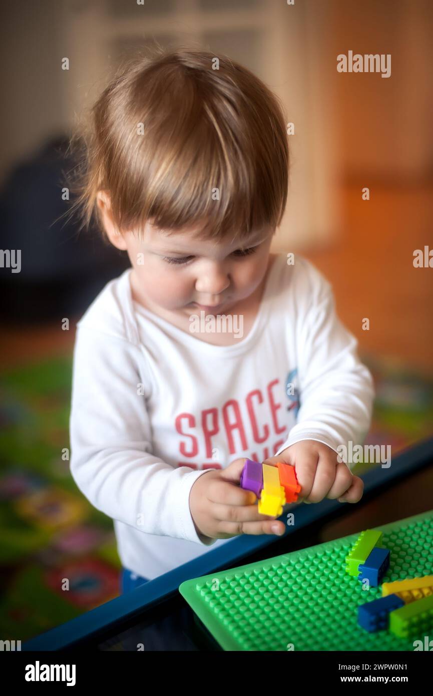Lego blocks. Happy child, cute toddler boy playing and building with ...