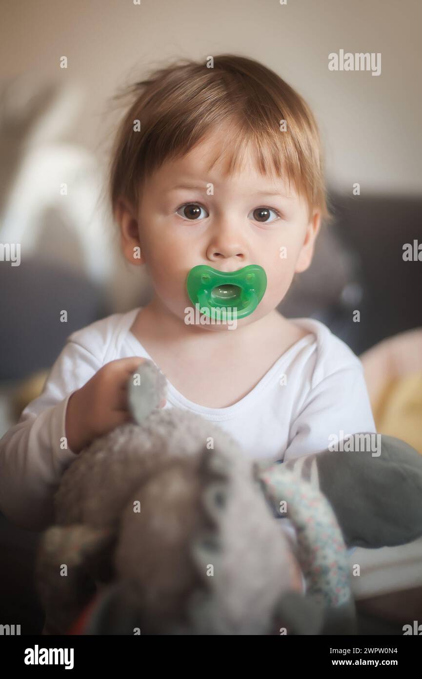 Tender moment between a happy cute baby boy and his favorite stuffed ...