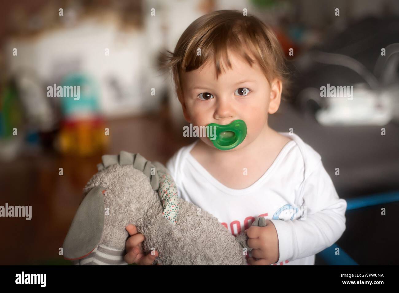 Tender moment between a happy cute baby boy and his favorite stuffed ...