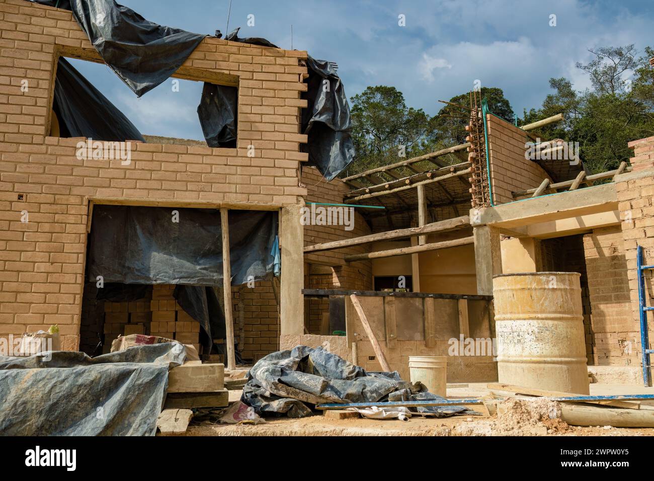 Closer look of a messy construction site of an adobe bricks house, near ...