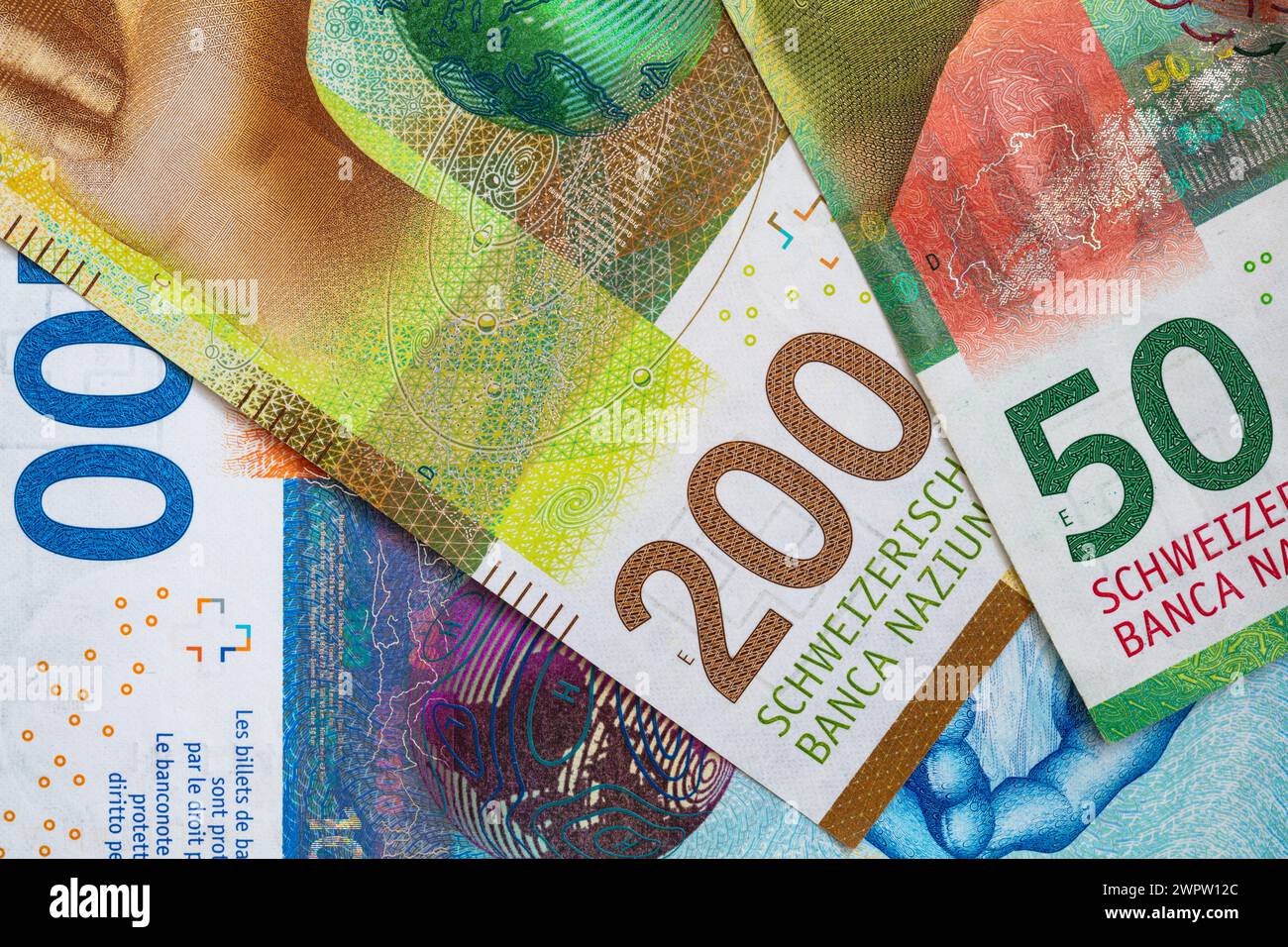 Closeup of 50, 100 and 200 Swiss franc banknotes for design purpose ...