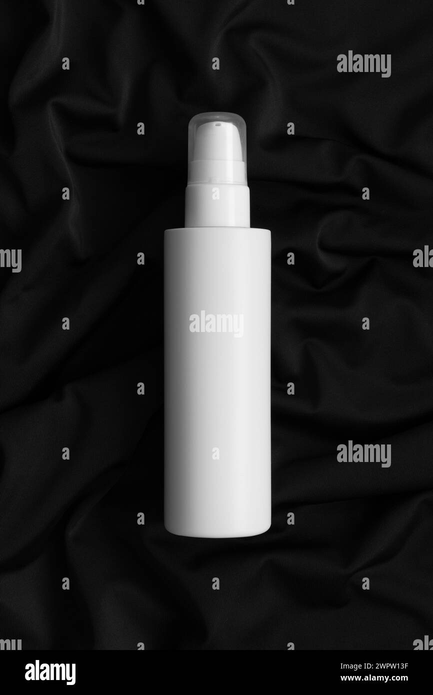 White cosmetic lotion bottle mockup on the black textile Stock Photo ...