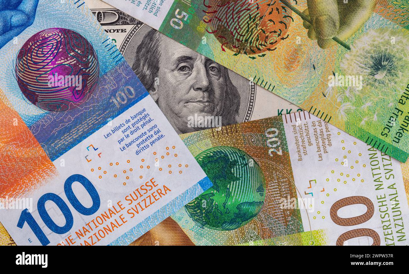 Closeup of 50, 100 and 200 Swiss franc banknotes and 100 dollar ...