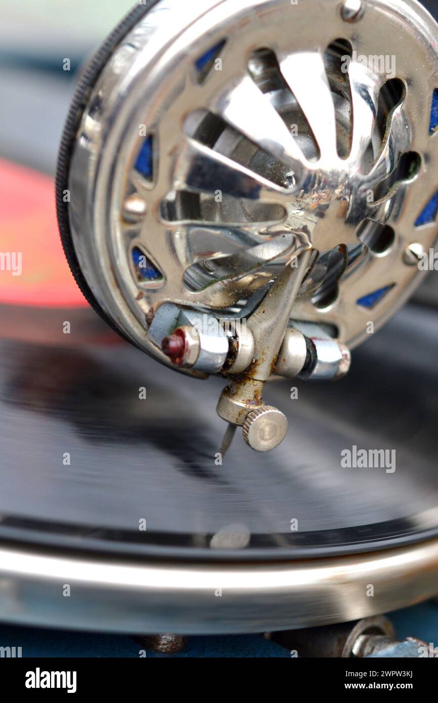 An old retro record playing on old vintage gramophone at flea market ...