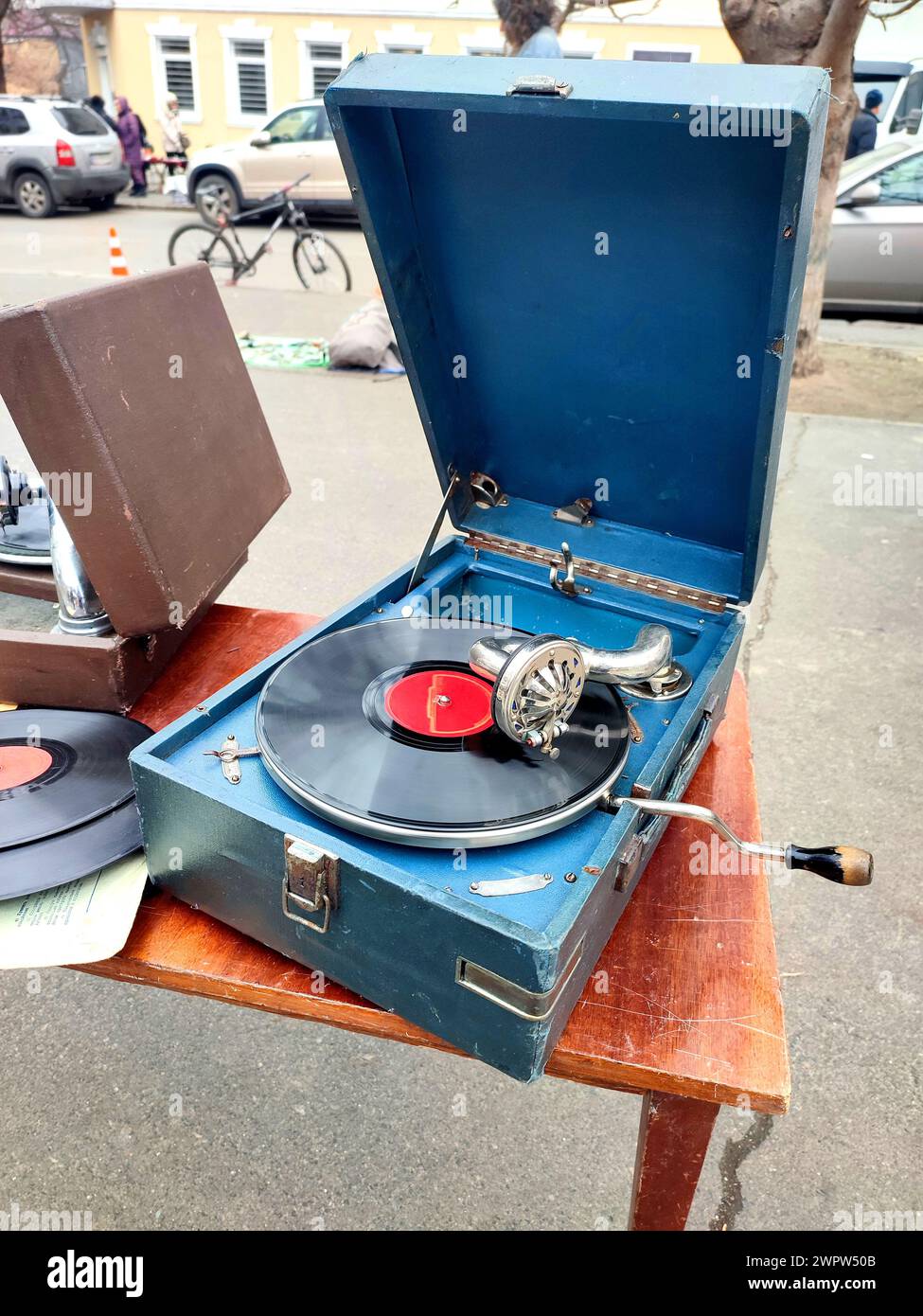 An old retro record playing on old vintage gramophone at flea market ...