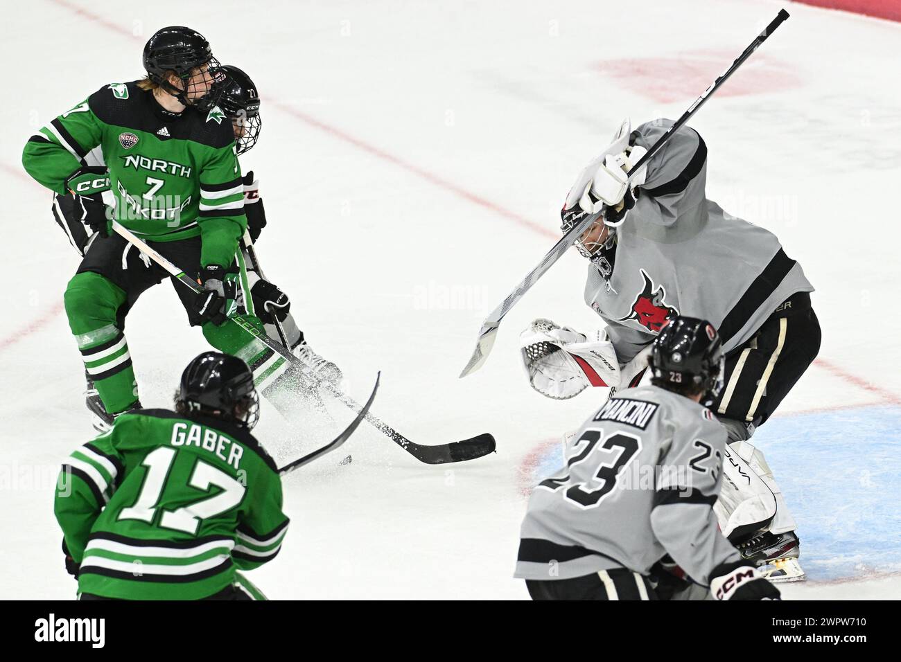 Omaha Mavericks goaltender Simon Latkoczy (30) deflects a shot by North Dakota Fighting Hawks ...