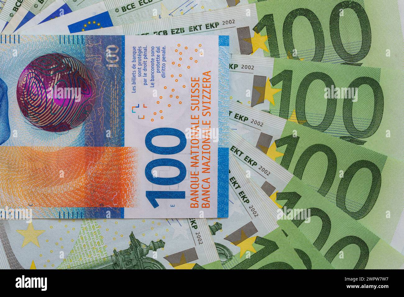 Closeup of 100 Swiss franc banknote and 100 euro banknotes for design ...