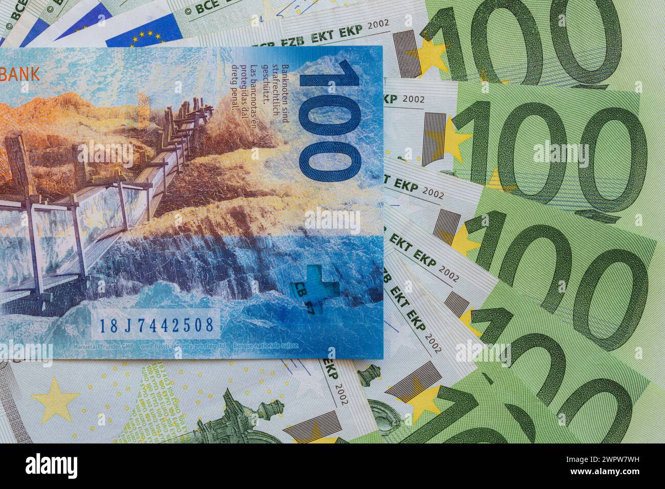 Closeup of 100 Swiss franc banknote and 100 euro banknotes for design ...