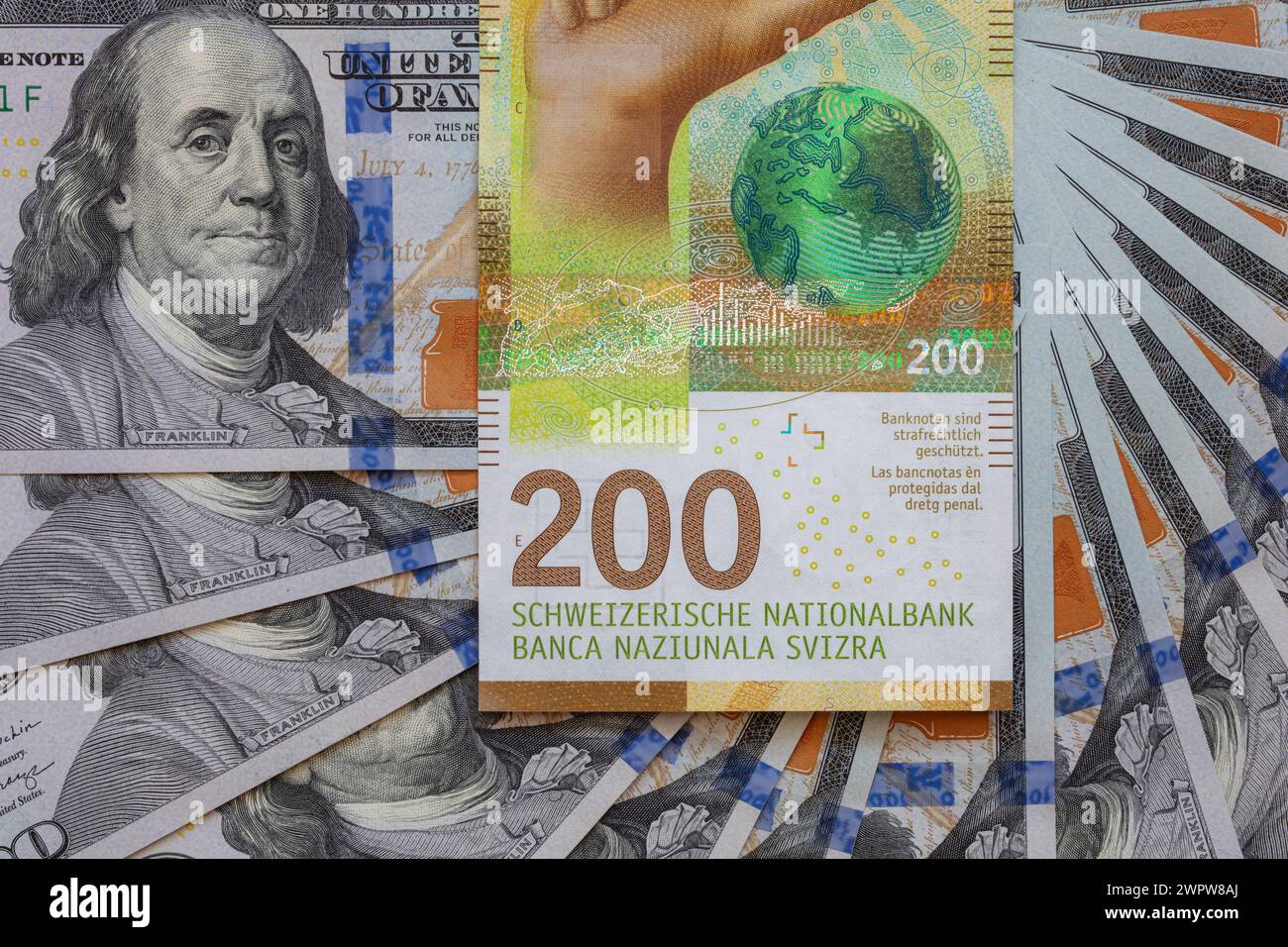 Closeup of 200 Swiss franc banknote and 100 dollar banknote for design ...