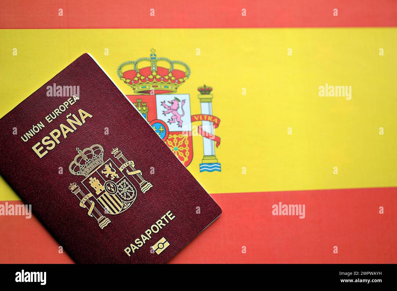 Red Spanish passport of European Union on national flag background ...