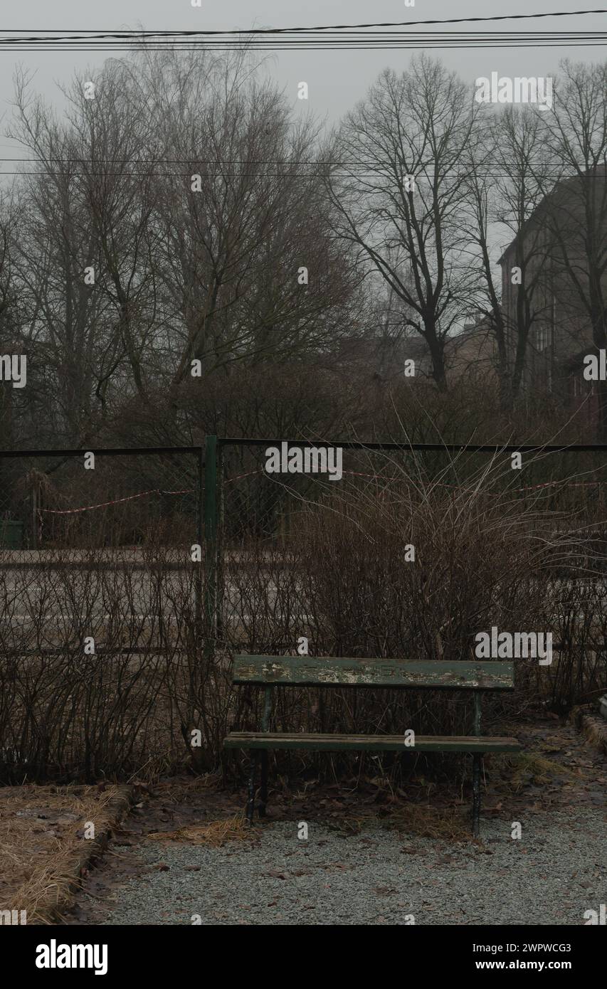 old dirty bench with metal fence foggy background Stock Photo - Alamy