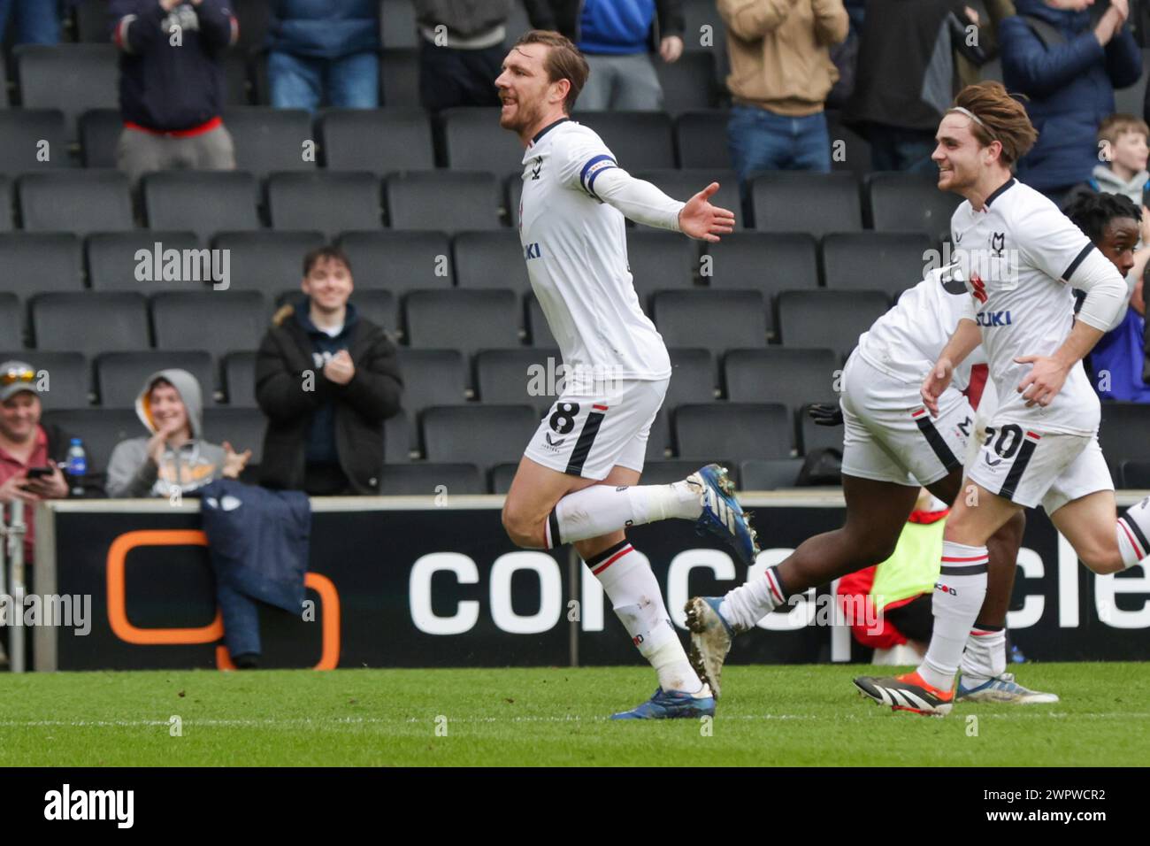captain Alex Gilbey celebrates after scoring for Milton Keynes Dons, to ...