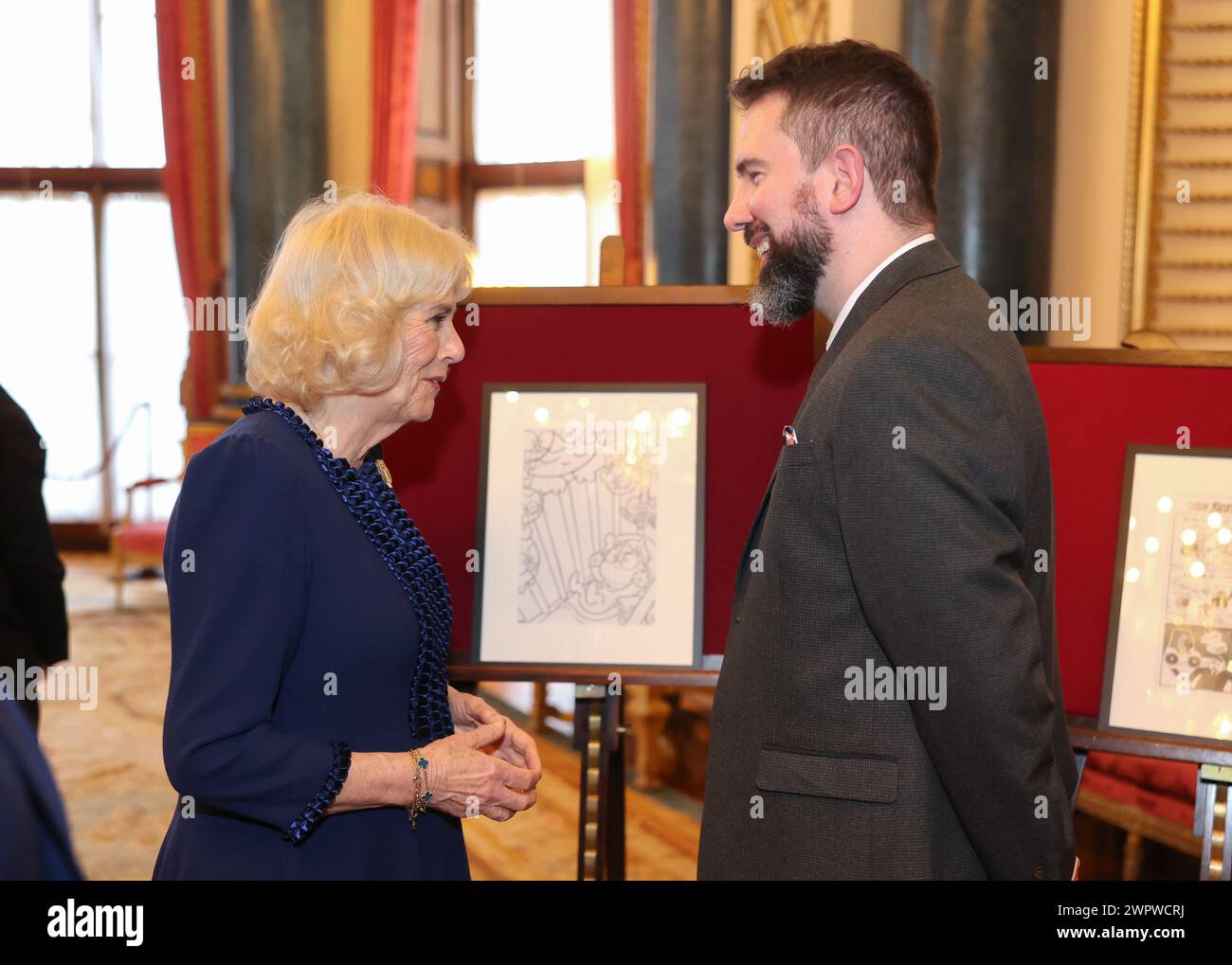 Queen Camilla speaks with illustrator Jamie Smart during a reception ...
