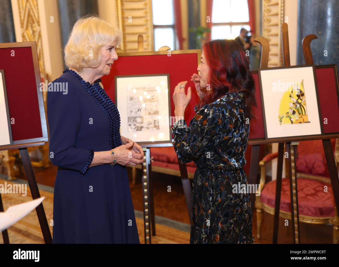 Queen Camilla speaks with illustrator Sue Cheung during a reception for ...