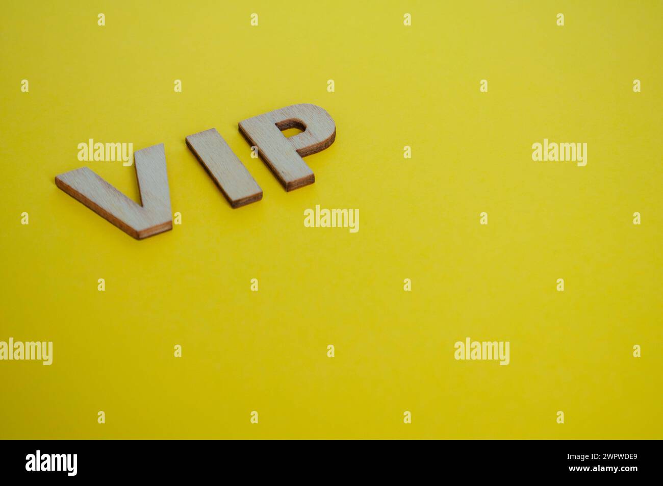 VIP wooden letters representing Very Important People on yellow ...