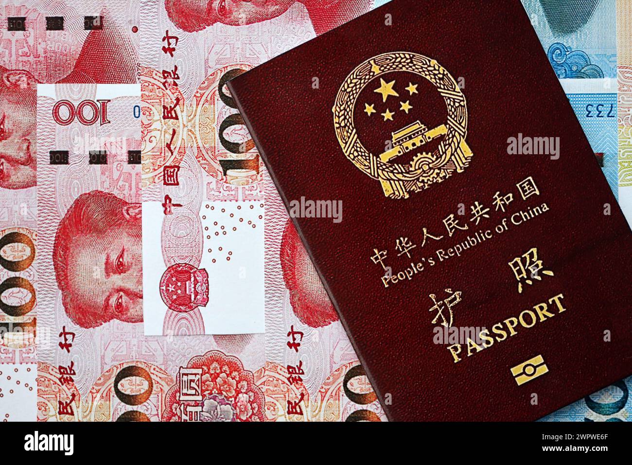 Red passport of People Republic of China and chinese yuan money bills ...