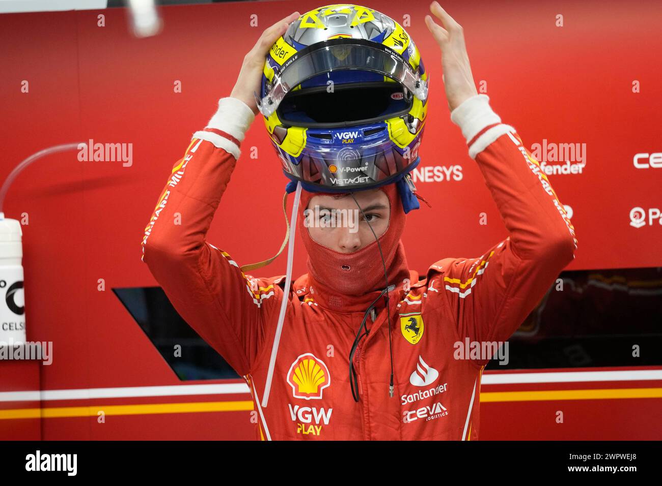 Ferrari driver Oliver Bearman of Britain wears the helmet prior to the ...