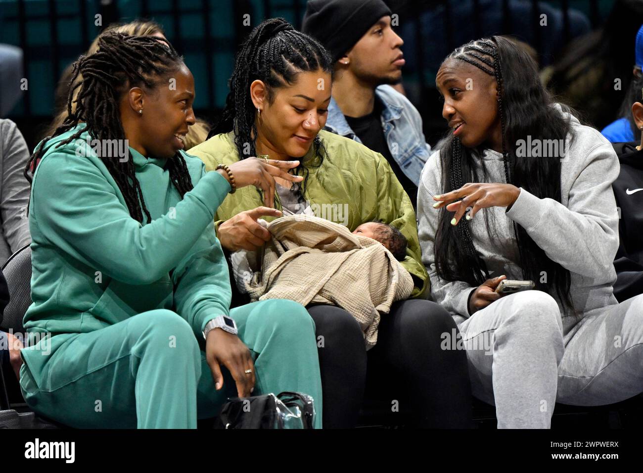 Las Vegas Aces' Chelsea Gray; her wife, Tipesa Gray; and Aces' Jackie ...