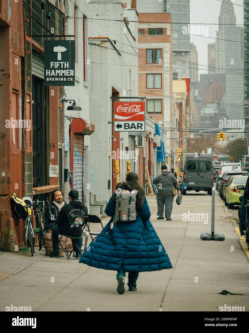 Woman wearing a big jacket and Gutter Bar LIC vintage sign in Long ...