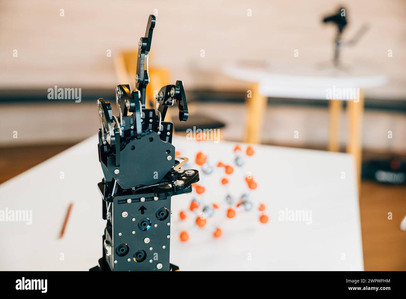 Cyborg mechanical arm features a black real robot hand making contact ...