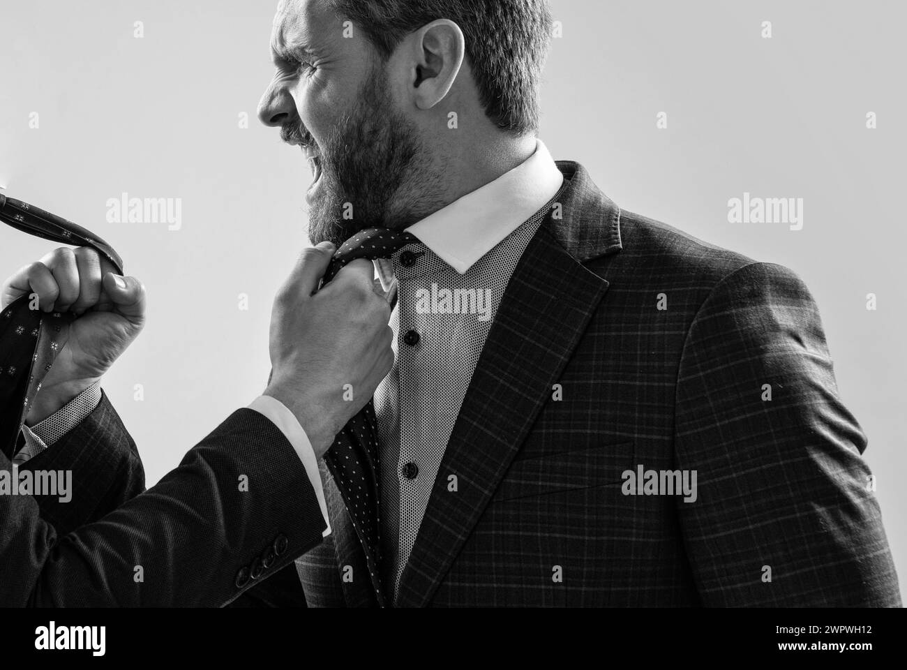 Angry man businessman scream pulling and being pulled by necktie during ...