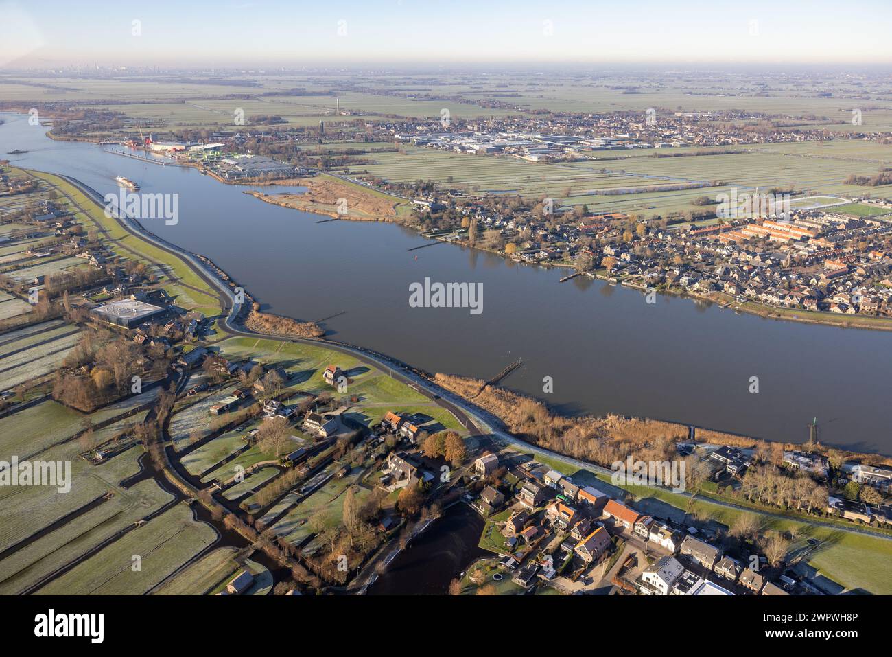 Aerial view flying above Dutch river Lek near Rotterdam with view at ...