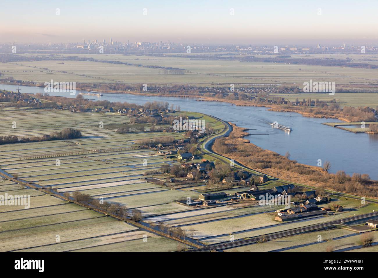 Aerial view flying above Dutch river Lek near Rotterdam with view at ...