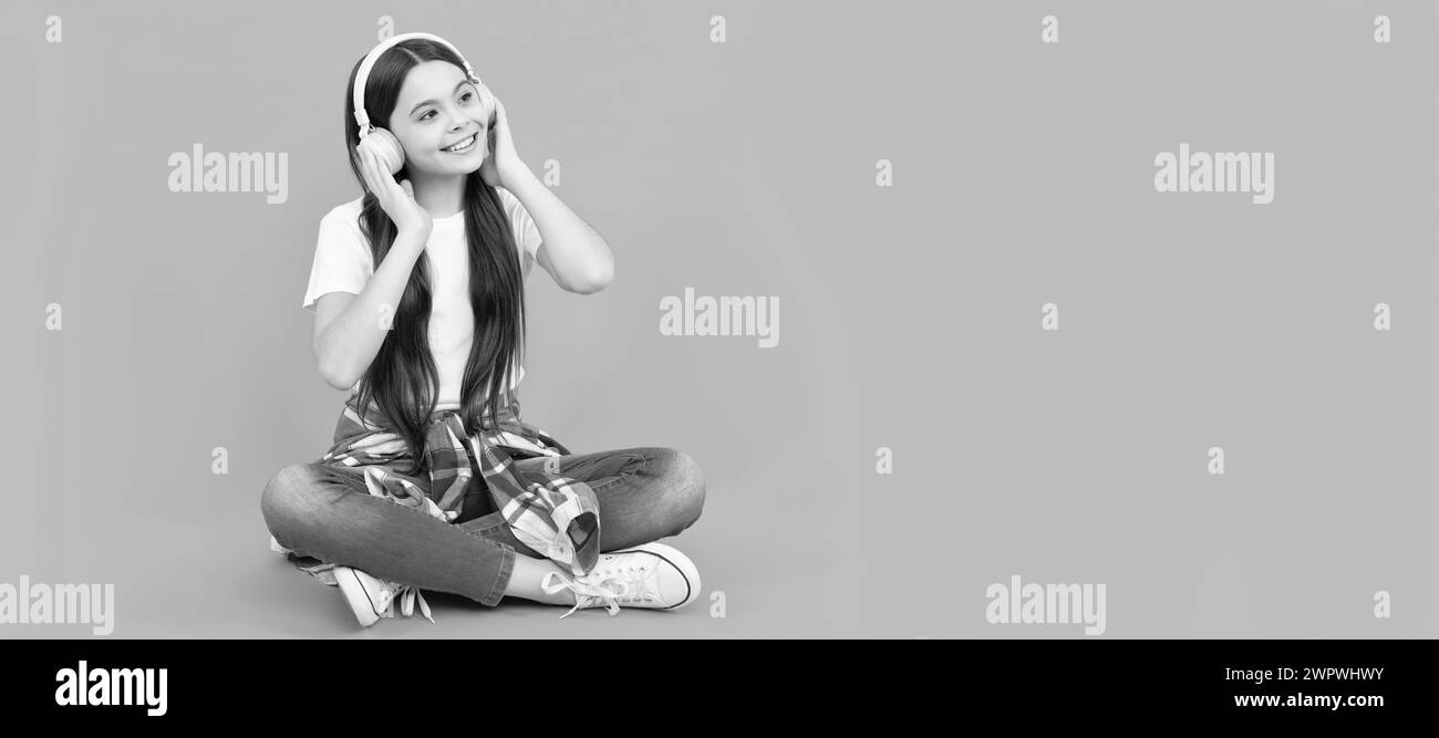 happy teen girl listen to music in wireless headphones. Child portrait ...