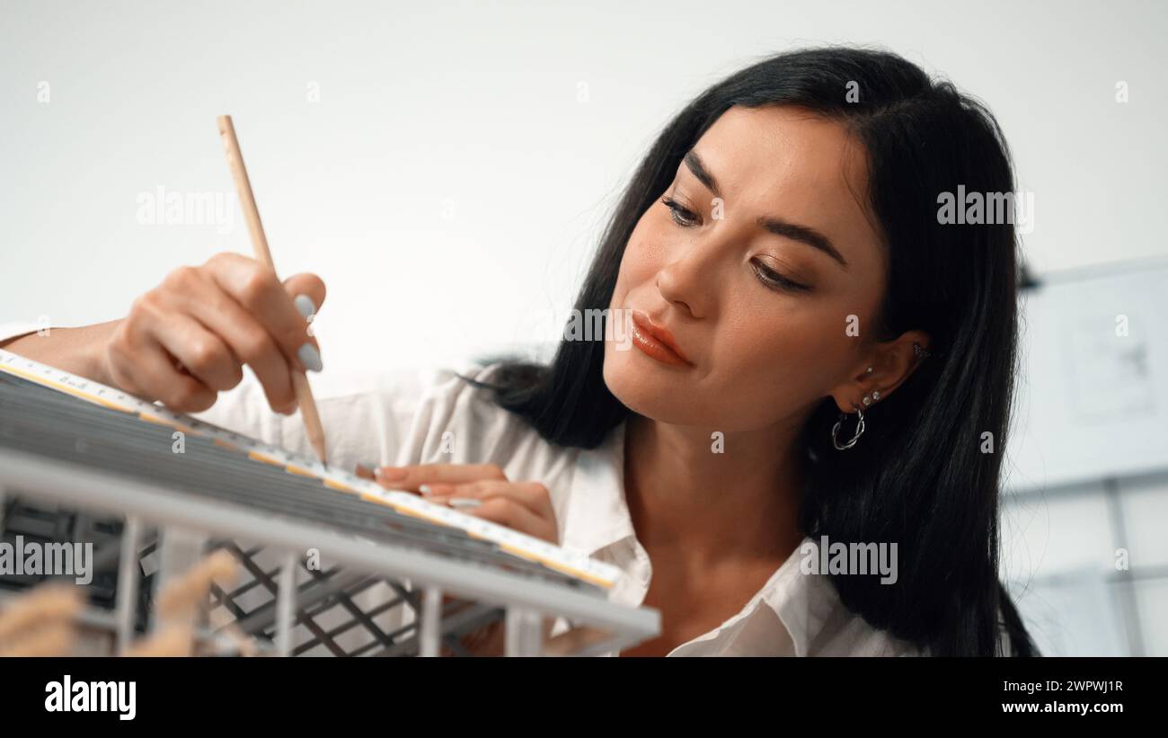 Professional young beautiful architect engineer using ruler and pencil ...