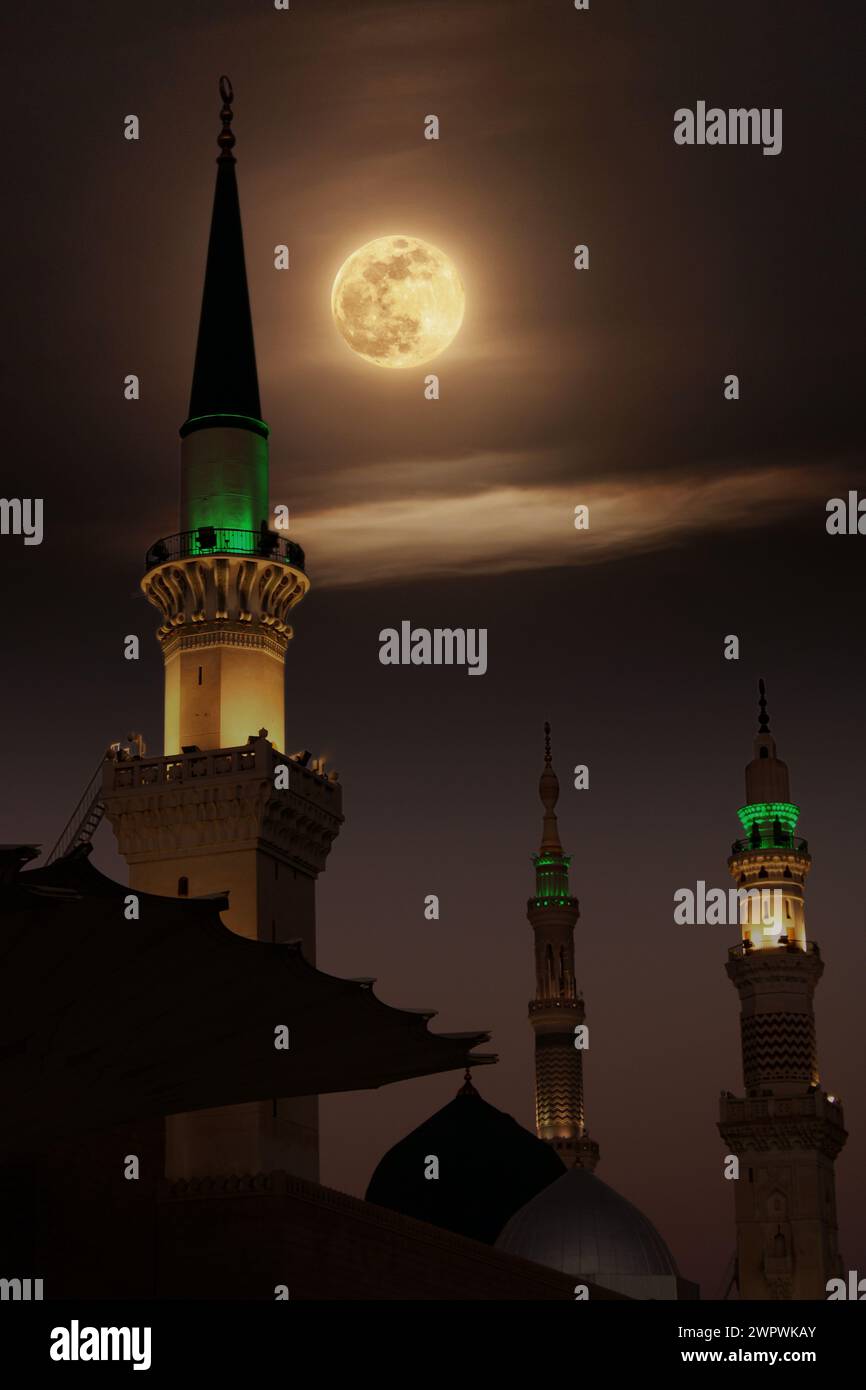 A mosque with the full moon in the sky. Masjid nabi of Medina, mosque ...