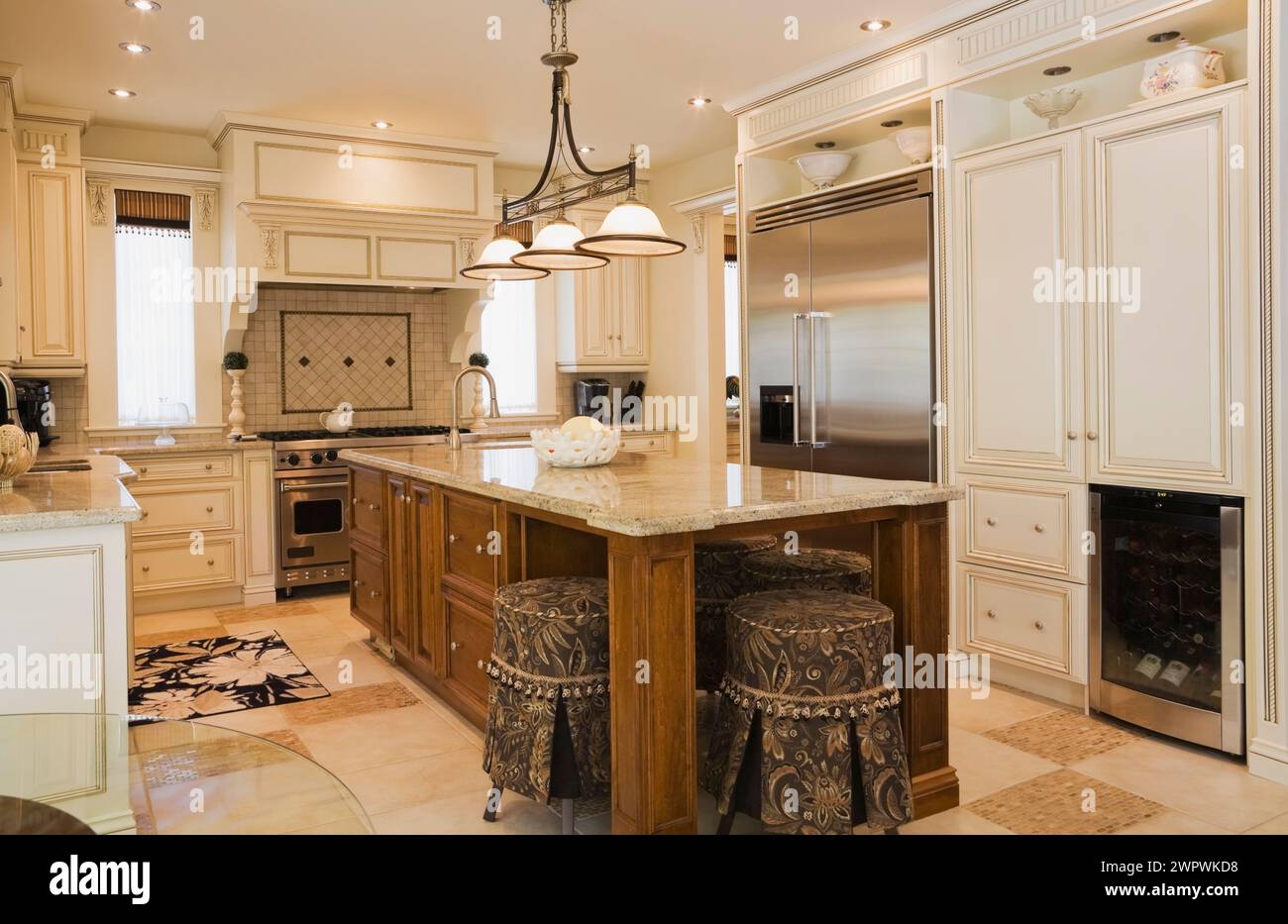 Modern kitchen with white cabinets and pendant lighting fixture with ...
