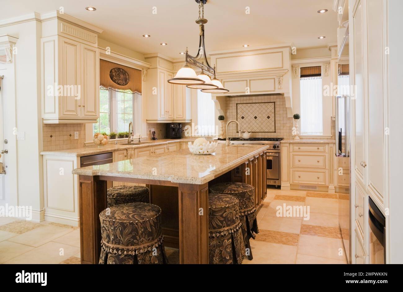 Modern kitchen with white cabinets and pendant lighting fixture with ...