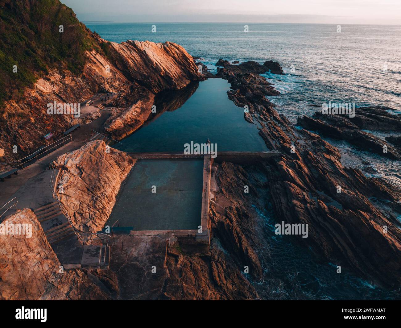 Aerial drone view of Blue Pool in Bermagui during sunrise sunset with ...