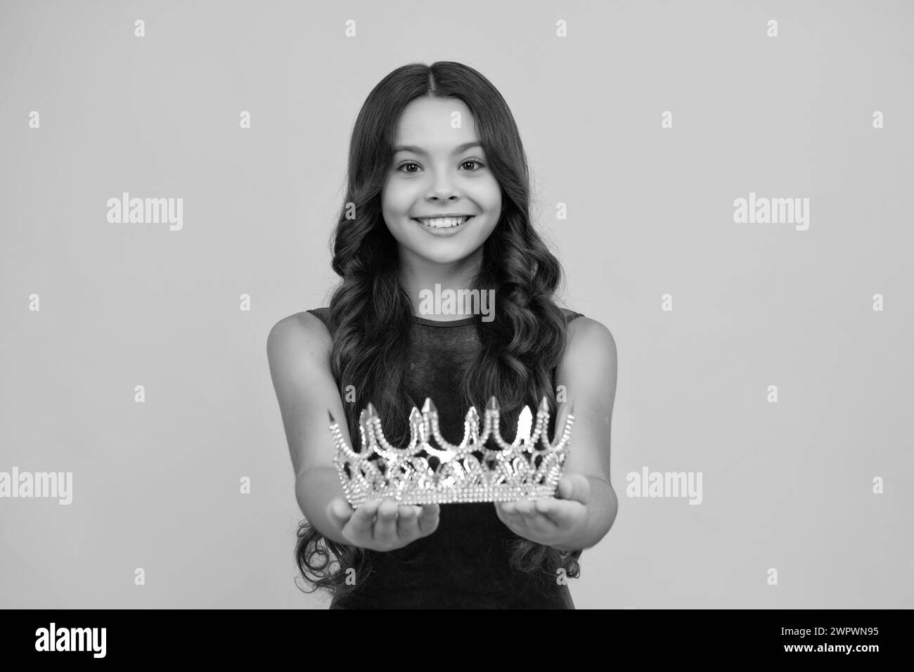 Little queen wearing golden crown. Teenage girl princess holding crown ...