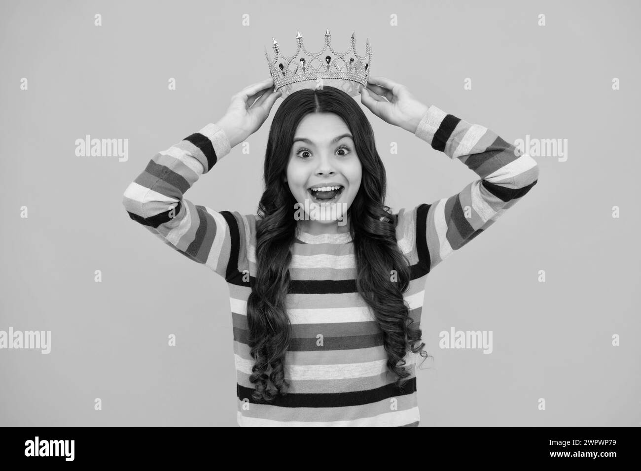 Amazed teenager. Little queen wearing golden crown. Teenage girl ...