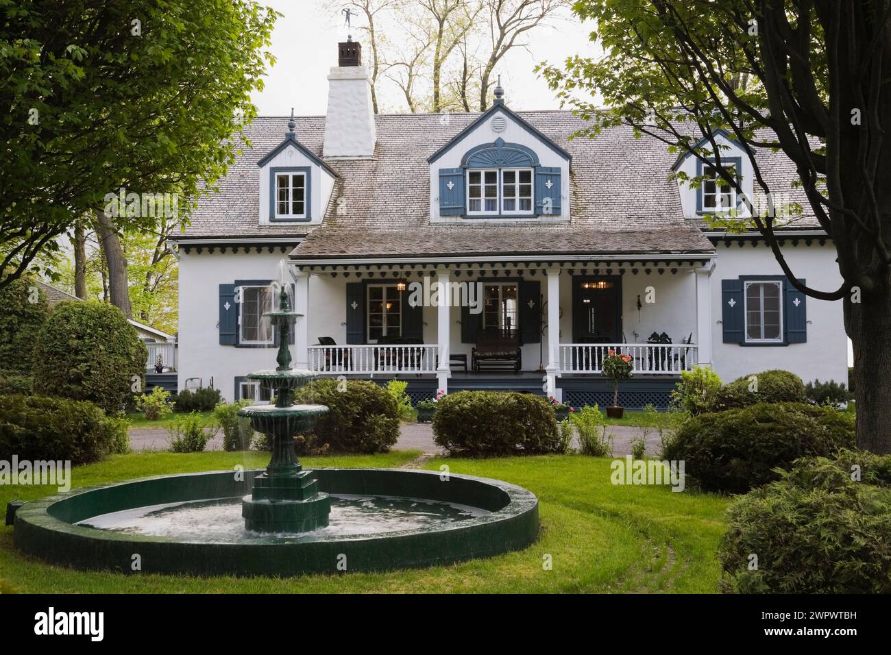 Old 1920s two story white with blue trim home facade with water ...