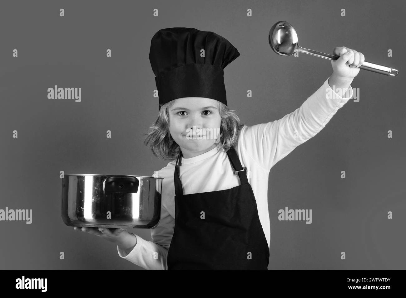 Child chef cook with cooking pot and ladle. Excited chef cook. Child ...