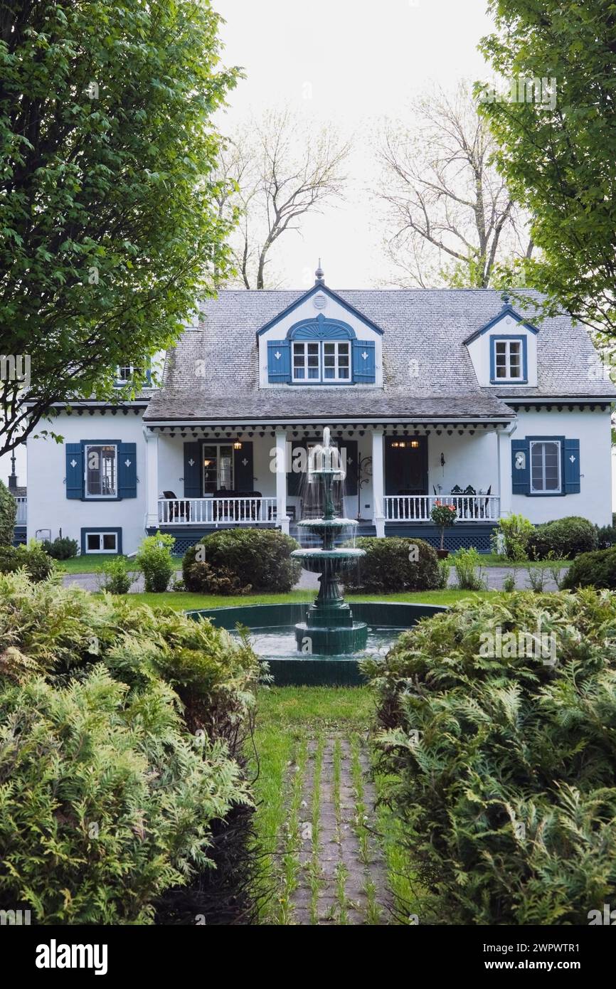 Old 1920s two story white with blue trim home facade with water ...