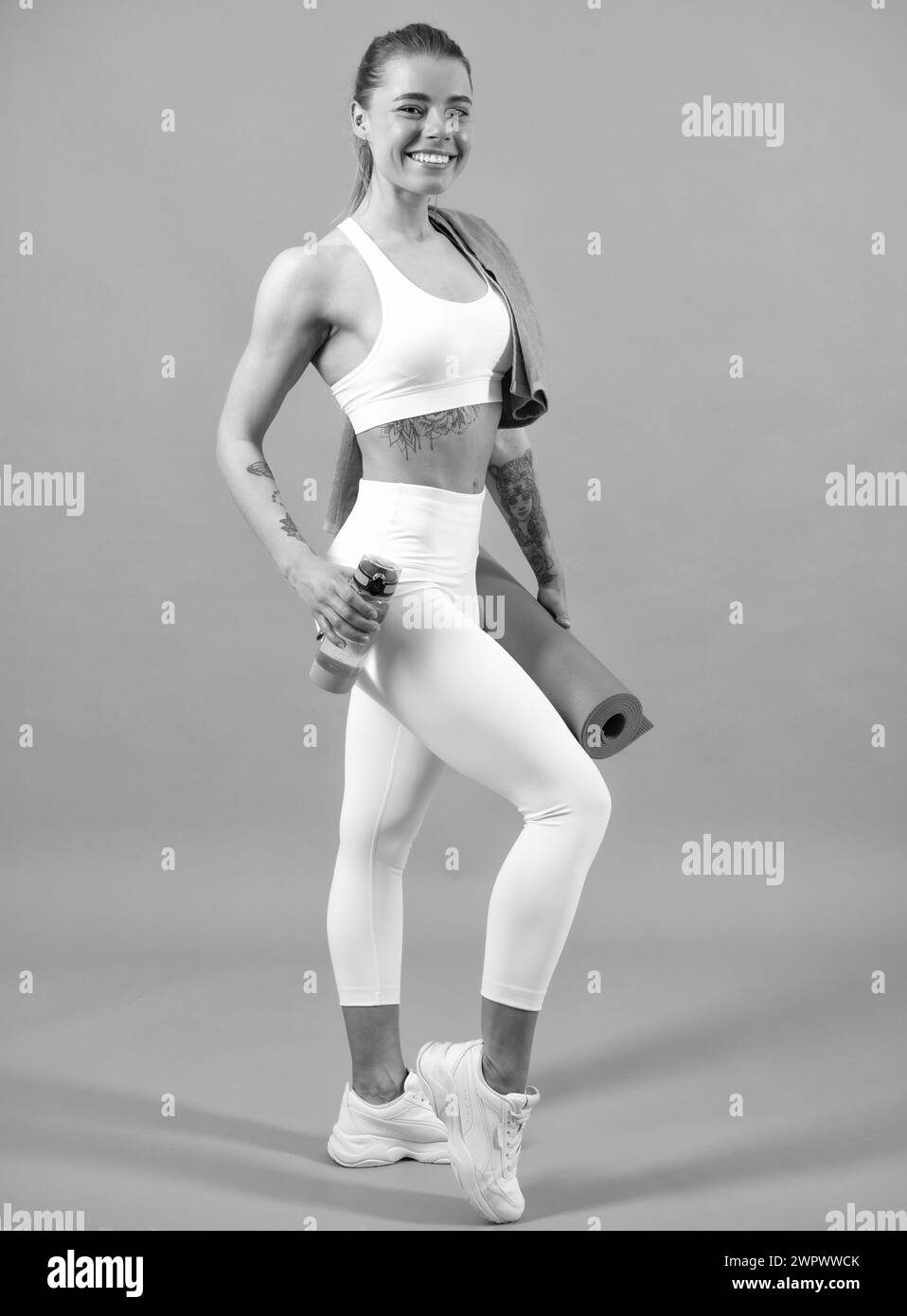 Beautiful strong happy cheerful sports woman posing on isolated background. Happy young woman in ...