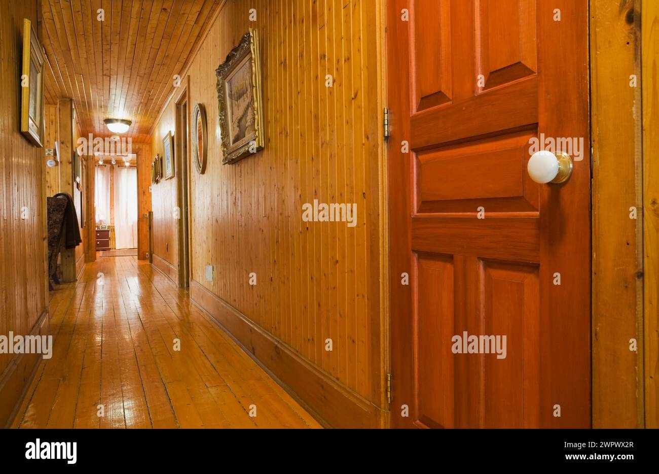 Hardwood floor hallway on upstairs floor inside old 1920s two story ...
