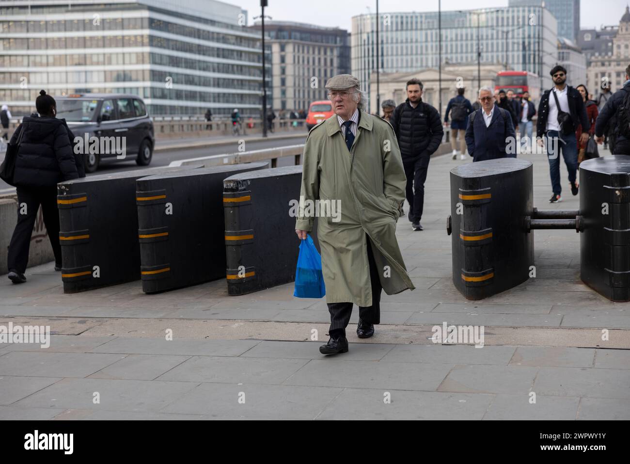 City workers make their way across London Bridge on their way home in ...