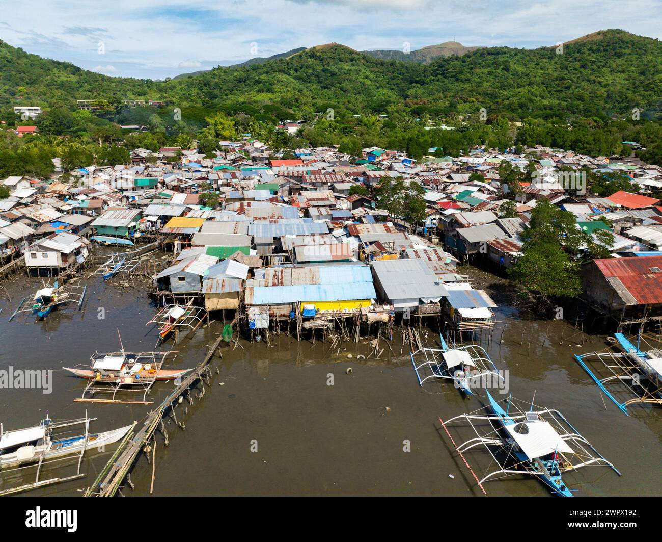 Stilt houses and boats on shoreline in Coron, Palawan. Philippines ...