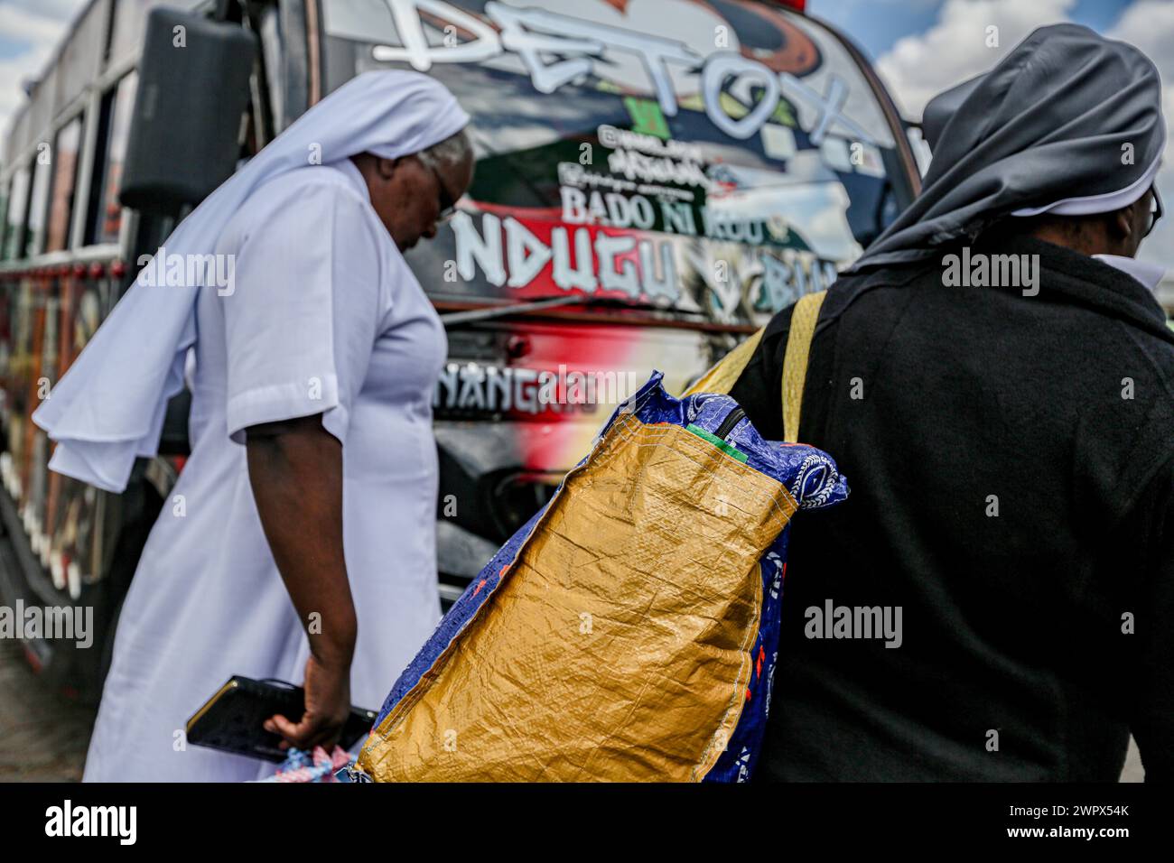 Nairobi, Nairobi, Kenya. 9th Mar, 2024. Two nuns walk past a matatu ...