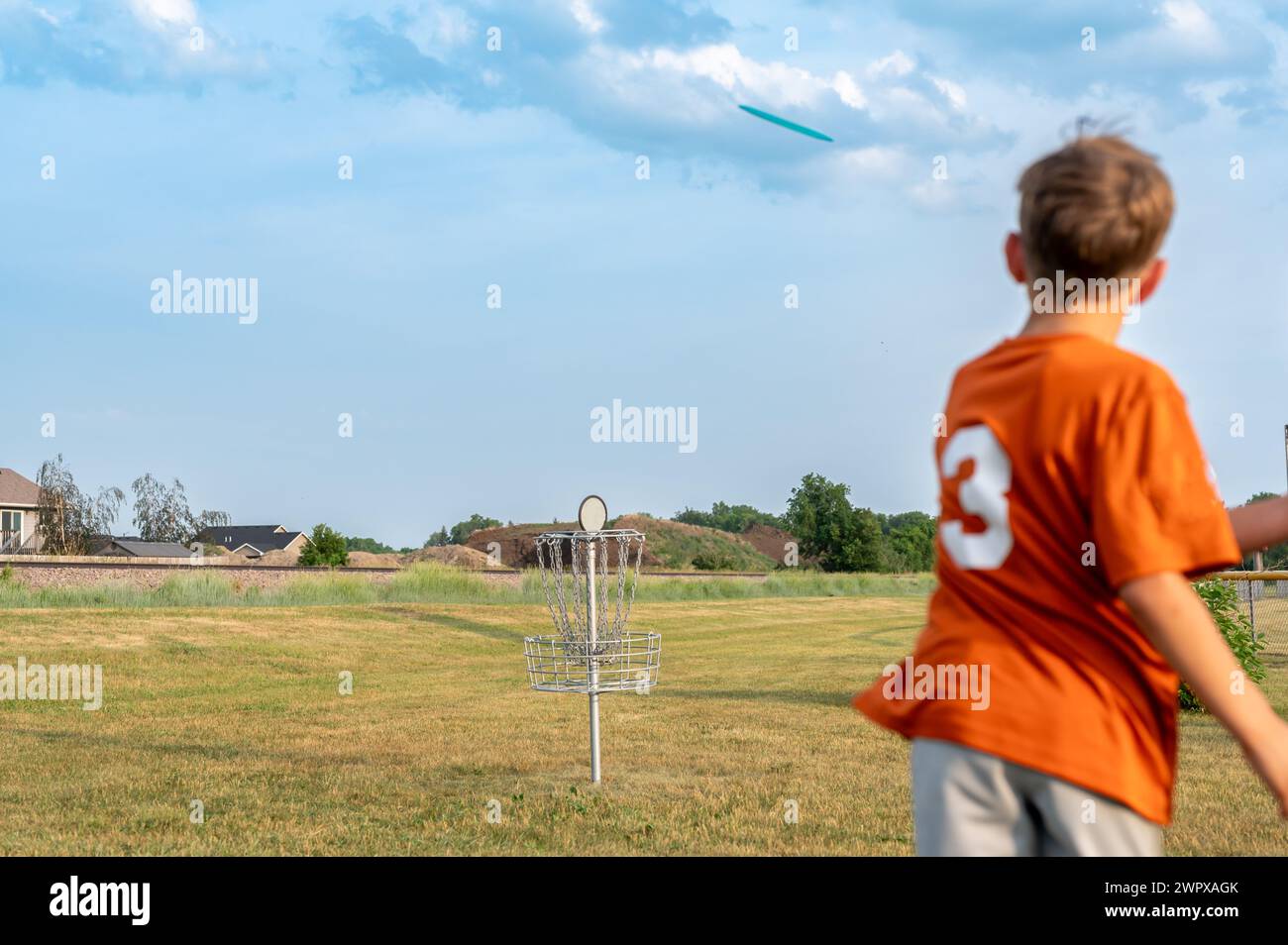 Selective focus fairway grass with a defocused young child holding a ...