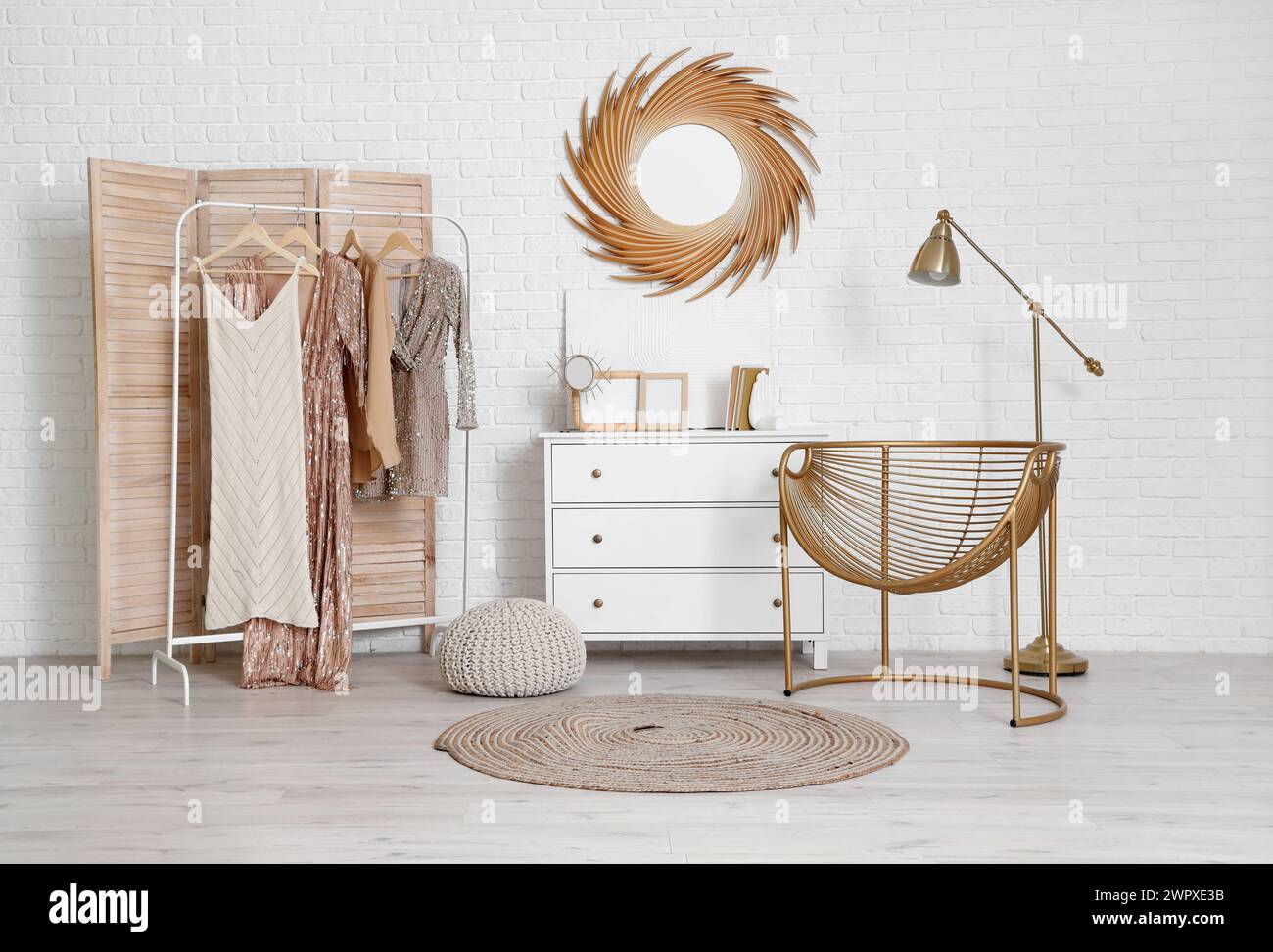 Interior of dressing room with golden mirror, clothes rack and commode ...