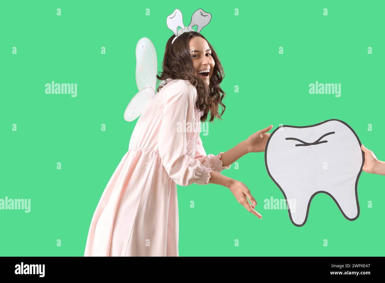 Tooth Fairy and paper figure on green background Stock Photo - Alamy